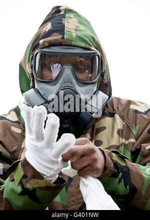 An Airman puts on protective gear during a readiness exercise at Travis ...