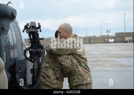 .S. Air Force flight engineer and his father pose in front of an HH-60 ...