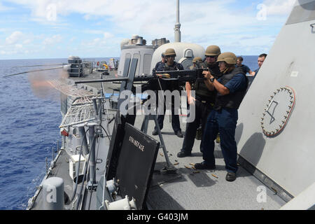 A midshipman fires a .50-caliber machine gun aboard guided-missile ...