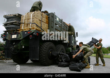 People offload supplies from a truck at the World Food Programme (WFP ...