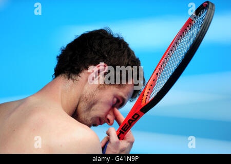 Britain's Andy Murray wipes the sweat from his face in his match ...