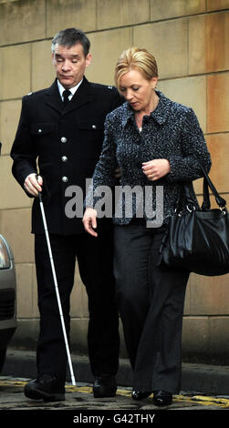 Police officer David Rathband arrives with his wife Katherine and son ...