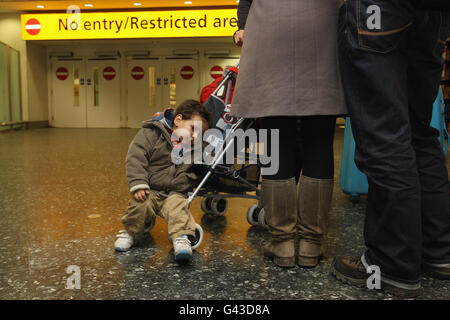 Two year old Omar Mant arrives with his father Robert Mant, at Gatwick ...