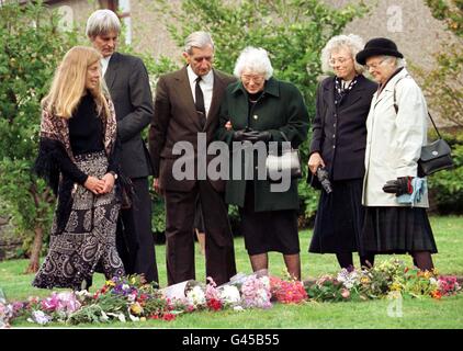 Dr Shaun Russell and daughter Josie walk away from the graveside after ...