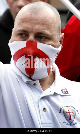 English Defence League EDL member with can of lager glaring and ...