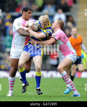 Warrington Wolves' Rhys Evans is tackled by Brisbane Broncos' Jordan ...
