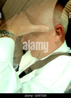 Bob Dowler, the father of Milly Dowler covers his face as he leaves the ...