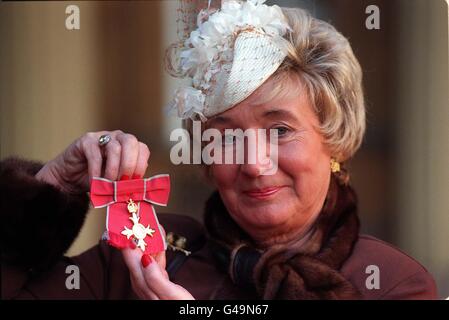 Vera Weisfeld, holds up her OBE as she poses with her son Michael ...