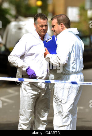 Police officers inside the cordon in Hainault, north east London, where ...