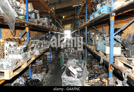 Garage raid in London. Engine parts are seen as police officers raid ...