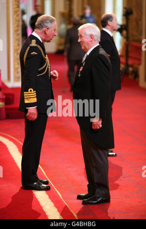John Moore is presented with his MBE by the Prince of Wales, at the ...