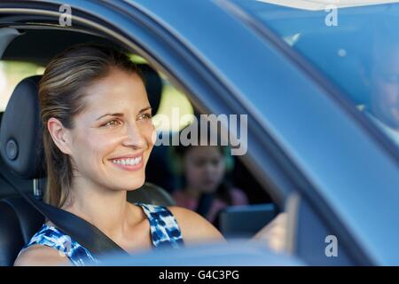 Young woman driving car looking at camera with a happy expression Stock ...
