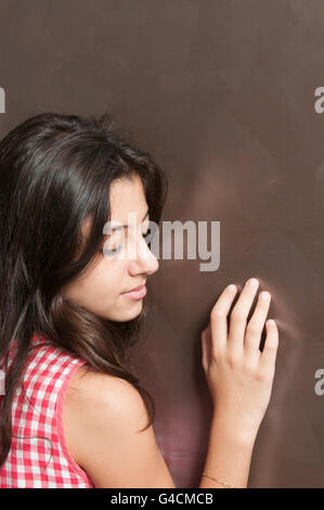 Sad girl hand touching wall Stock Photo - Alamy