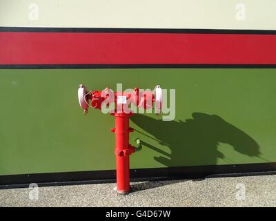 Fire water hoses and fire extinguisher equipment in red cabinet isolate ...