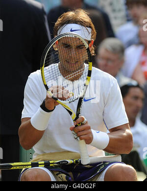 Spain's Rafael Nadal adjusts his racquet in his match against Great ...