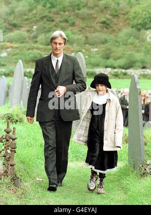 Dr Shaun Russell and daughter Josie walk away from the graveside after ...