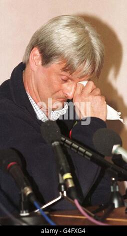 Dr Shaun Russell and daughter Josie walk away from the graveside after ...