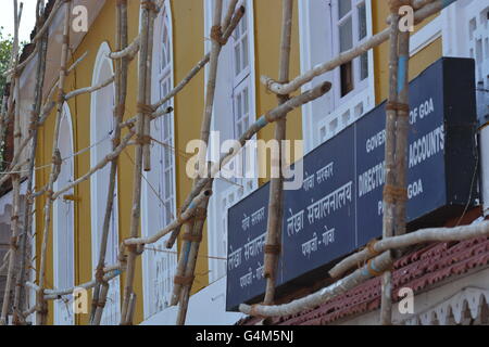 Indian workers on a bamboo scaffold give finishing touches to a huge ...
