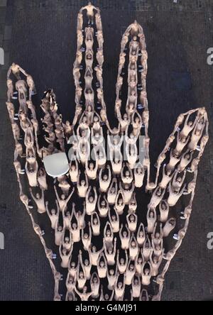 A giant human hand is formed by 200 in London's Covent Garden to ...