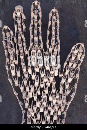A giant human hand is formed by 200 in London's Covent Garden to ...