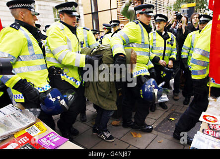 Police detain a student during a protest against the government's ...