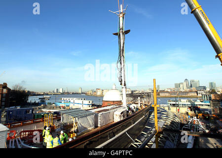 The Cutty Sark's foremast is lifted into place, at the ship's permanent ...