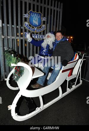 Everton fans pose for photographs with Blue Santa in his sleigh outside ...