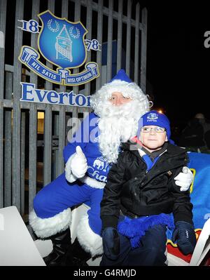 Everton fans pose for photographs with Blue Santa in his sleigh outside ...