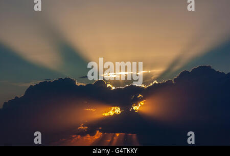 Dramatic sunset sky with beames of light through clouds Stock Photo - Alamy