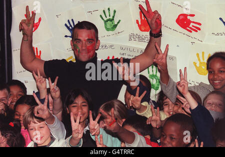 Robbie Williams with kids from Torriano Junior School in Kentish Town ...