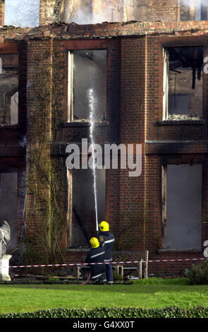 Firefighters hose down the home of Tory MP Michael Colvin after fire ...