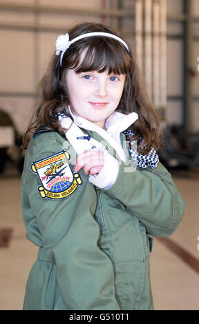 Nine-year-old Ellie Carter from Devon tries on a U2 pilot's gloves and ...