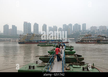 China, Chongqing, pier for Yangzte river cruise ships at night with ...