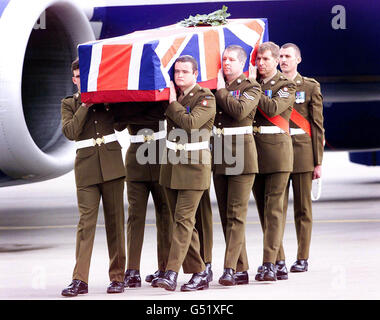 The coffin of British Brigadier Stephen Saunders is carried by military ...
