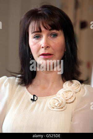 Nuala, mother of murdered Constable Ronan Kerr, holds photos of Ronan ...