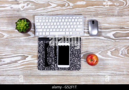 Keyboard mouse glasses pen notepad phone flower in pot on white ...