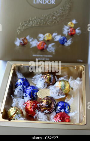 round gold wrapped chocolate sweets in a glass as part of a Wedding's ...