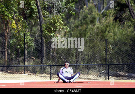 Great Britain's Jonathan Edwards sits next to the scoreboard showing ...