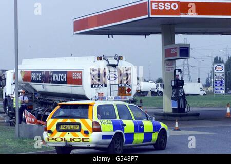 A police officer stands guard as an Esso tanker from the company's ...