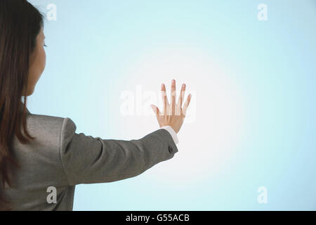 Japanese woman performing touch gesture Stock Photo - Alamy