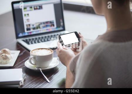 Female hand holding smartphone with CLOUD COMPUTING inscription, cloud ...