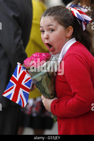 10-year-old Ellena Coglan from Accrington, presents a bouquet to Queen ...