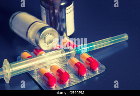 Colorful pills, blister and syringe on a black background Stock Photo ...