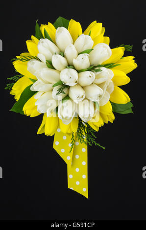 Yellow tulips in polka dot kraft envelope on dark weathered wooden ...