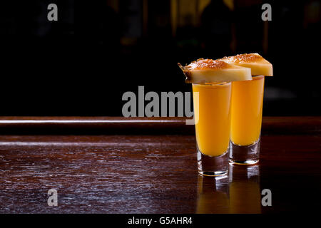 Tasty mango alcohol shots with pineapple and brown sugar Stock Photo ...