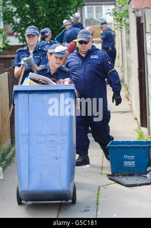 Tia Sharp death. Police officers search through rubbish bins near Tia ...