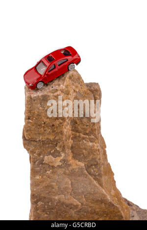 Little red model car on the top of a rock Stock Photo - Alamy