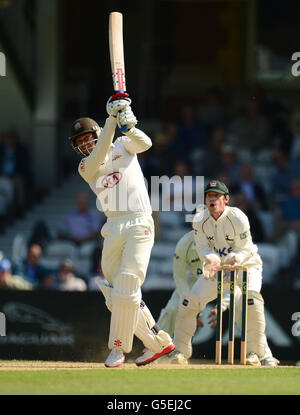Surrey's Zander De Bruyn hits past Middlesex's Sam Robson on his way to ...