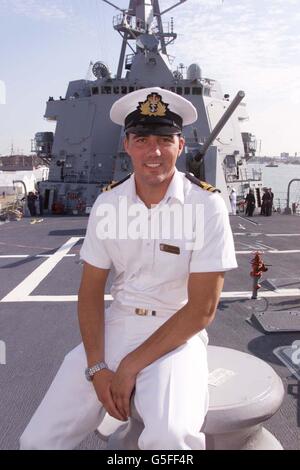 Royal Naval Lieutenant Angus Essenhigh takes a bearing on the bridge of ...