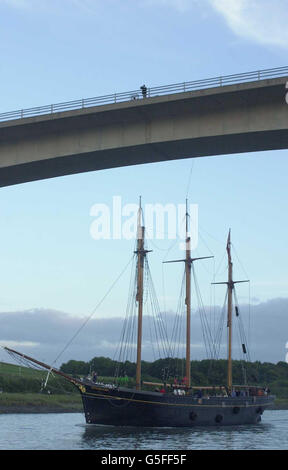 A tall mast boat passes under the raised Tower Bridge,completed in 1894 ...